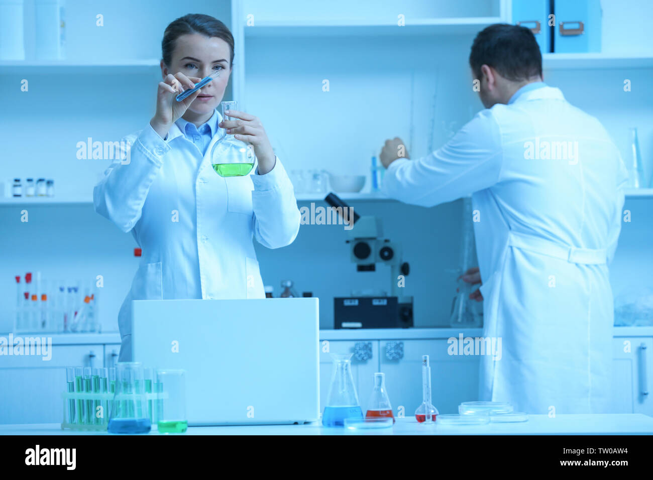 Female scientists working reagents hi-res stock photography and images ...