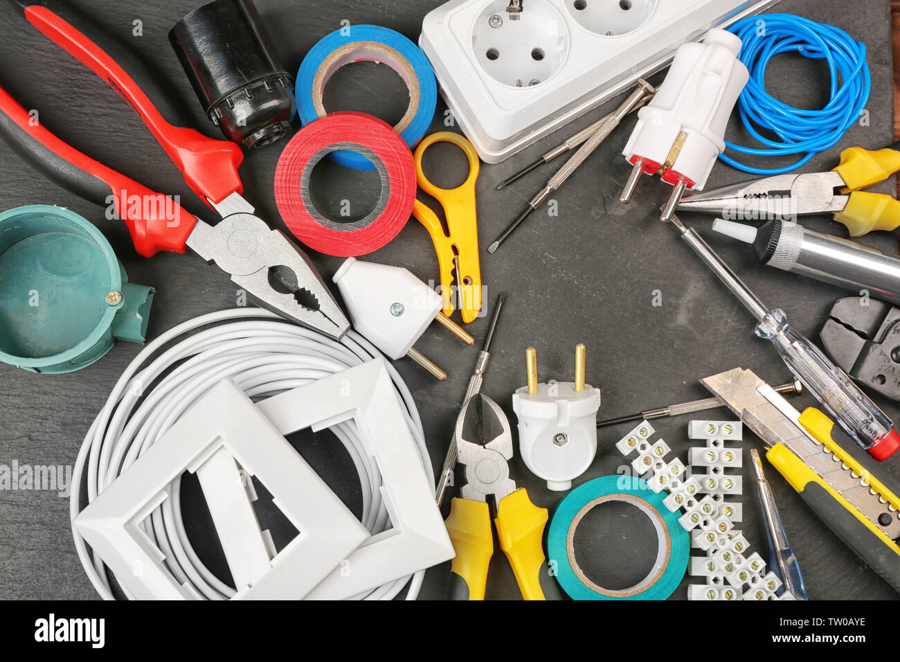 Different electrician tools on dark background Stock Photo - Alamy