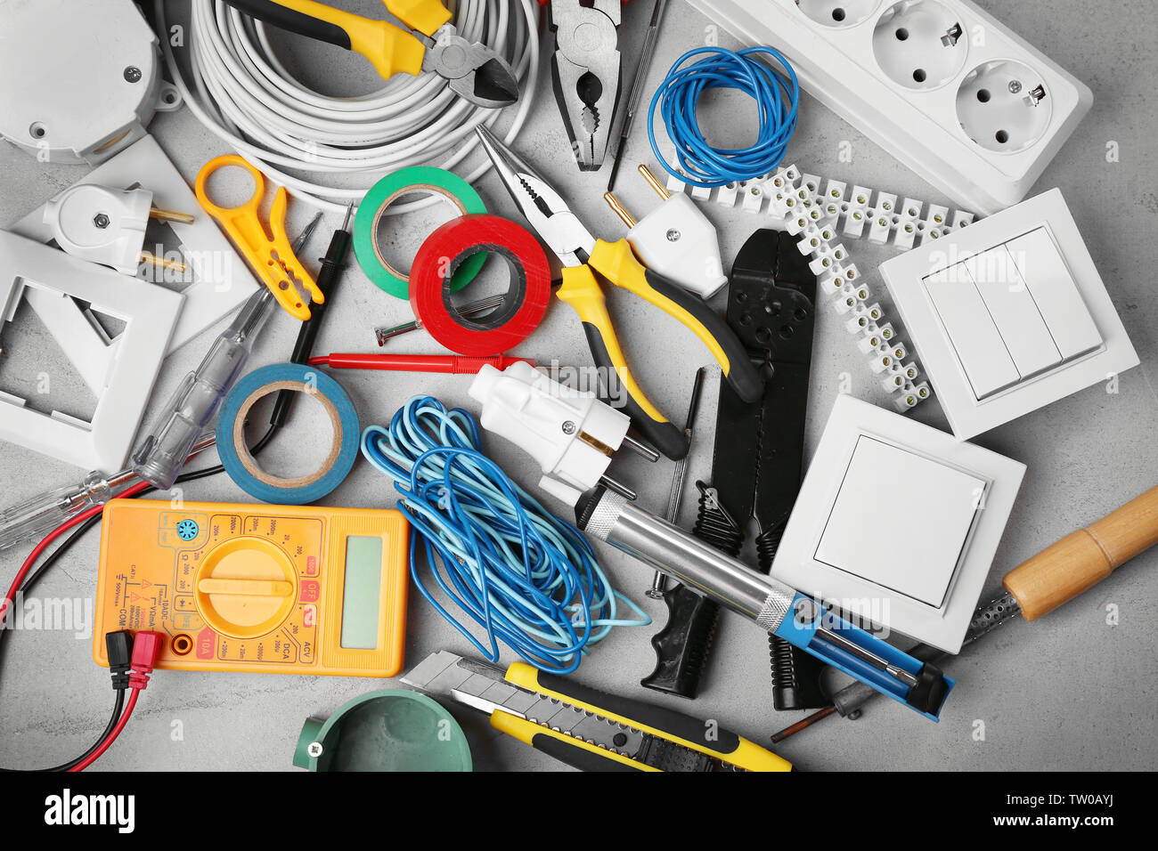 Electrician tools on grey background Stock Photo - Alamy