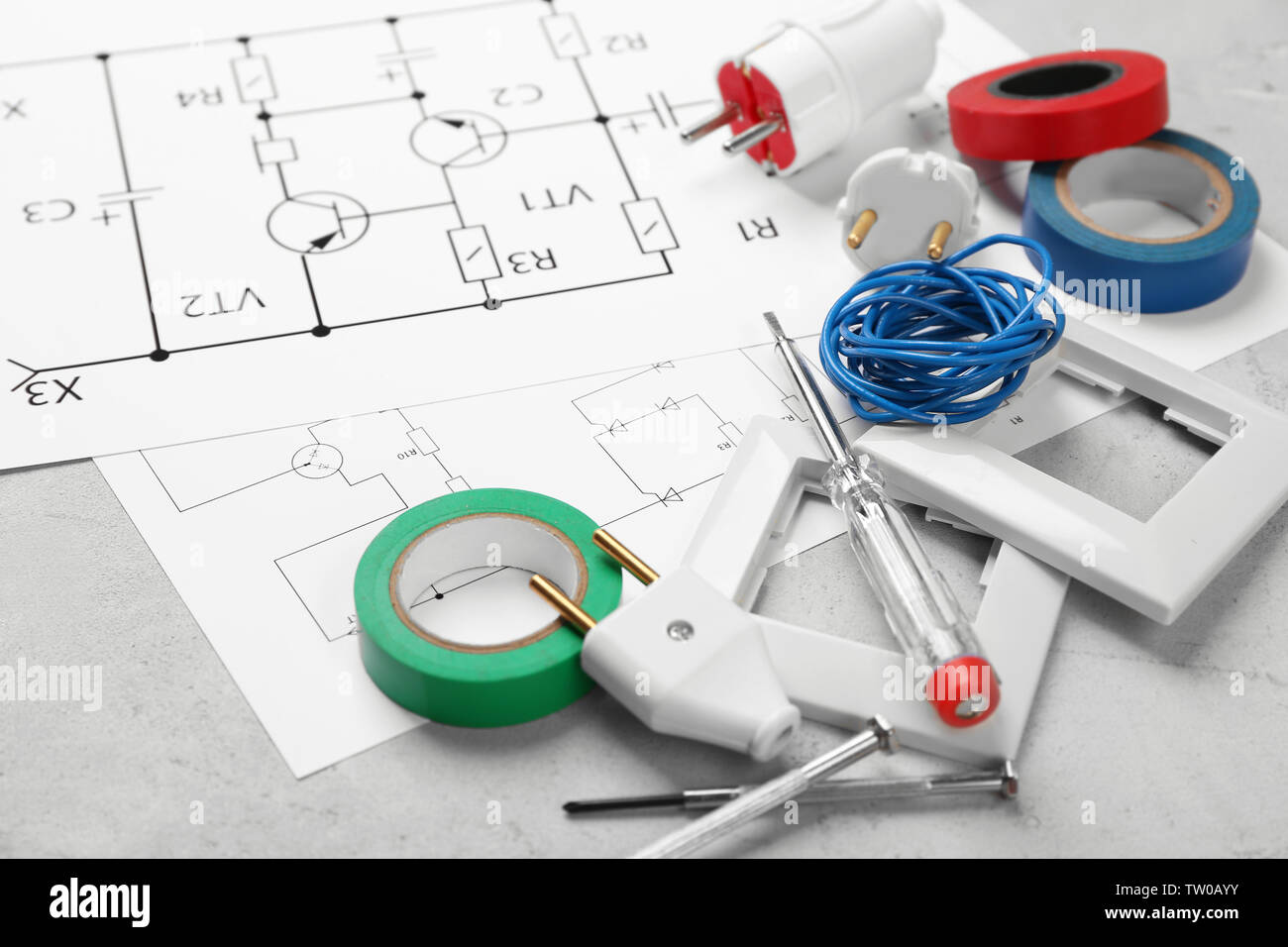 Electrician tools and schemes on grey background Stock Photo - Alamy