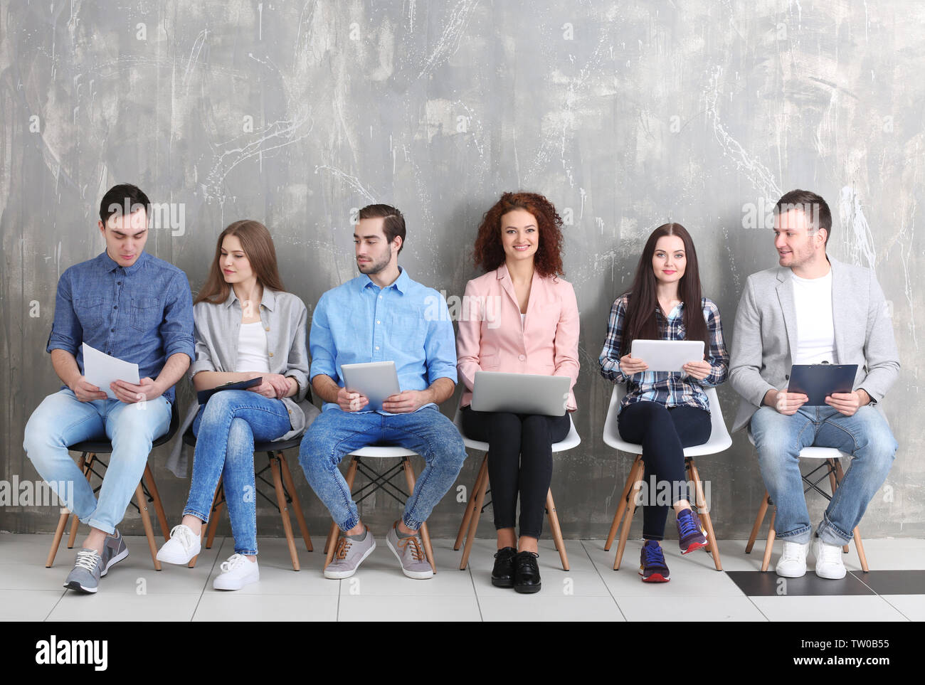Group of people waiting for job interview in hall Stock Photo - Alamy