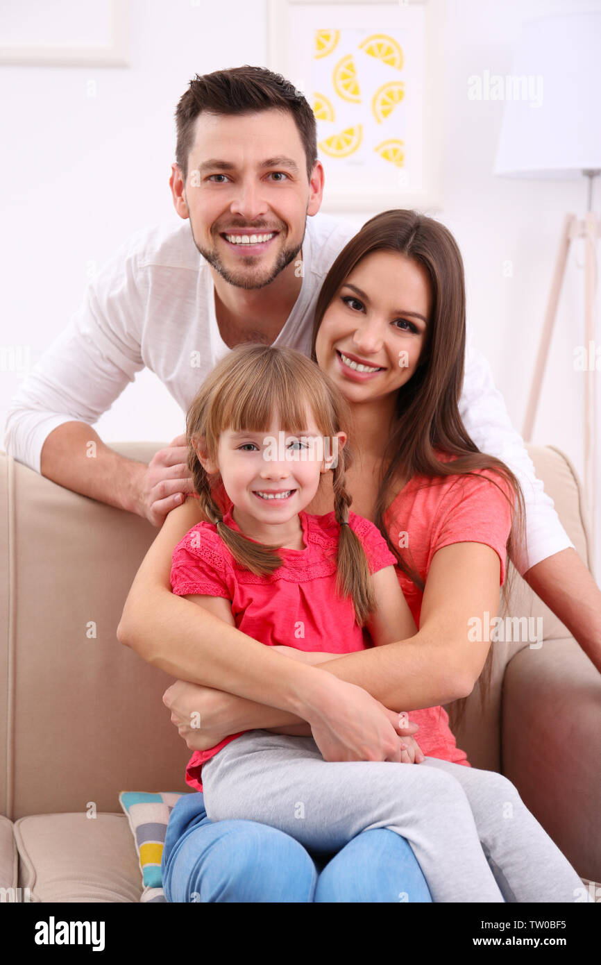 Happy family on sofa at home Stock Photo - Alamy