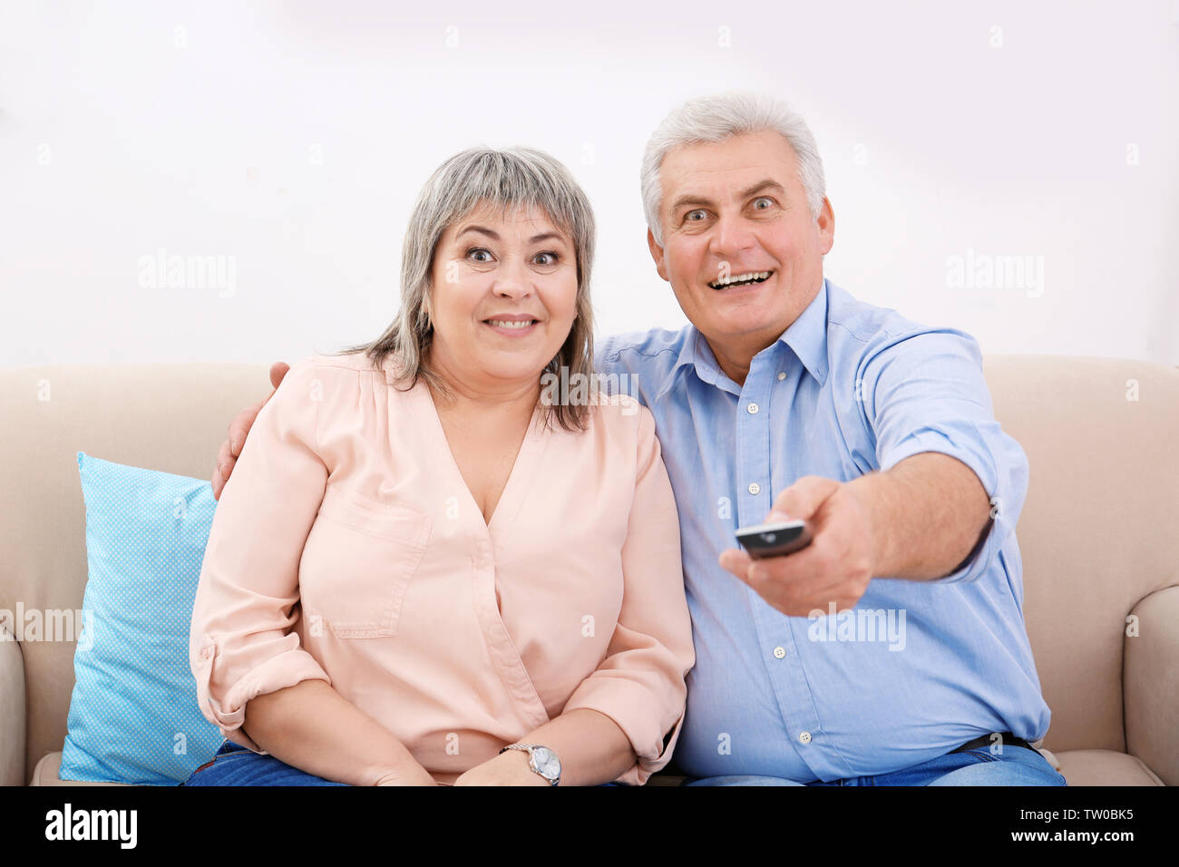 Middle aged couple watching TV at home Stock Photo - Alamy