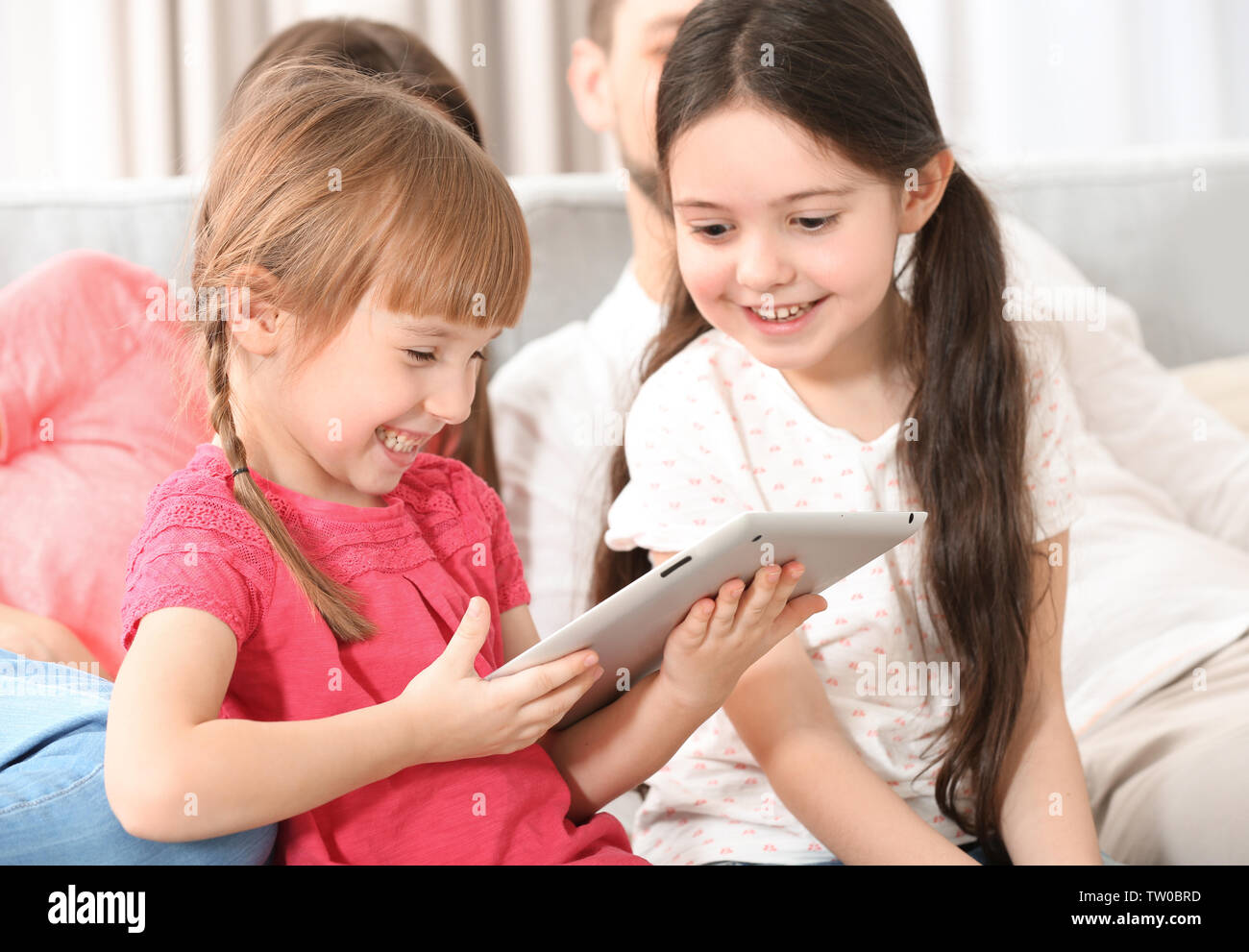 Little girls with tablet at home Stock Photo - Alamy