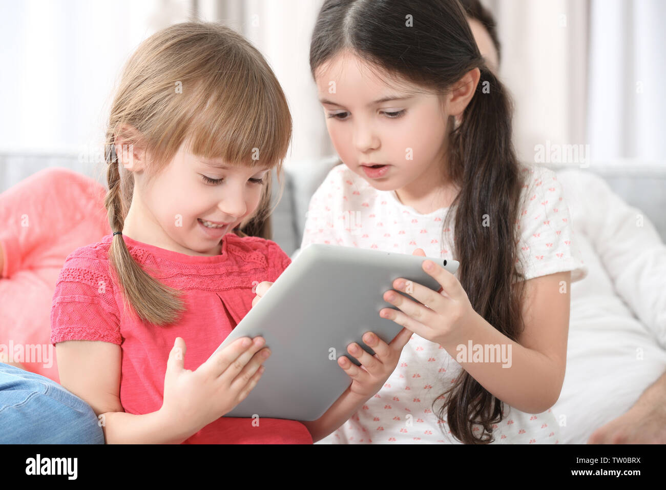 Little girls with tablet at home Stock Photo - Alamy
