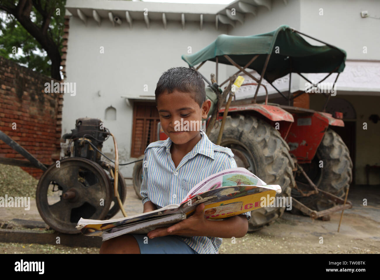 Boy reading a book, India Stock Photo - Alamy