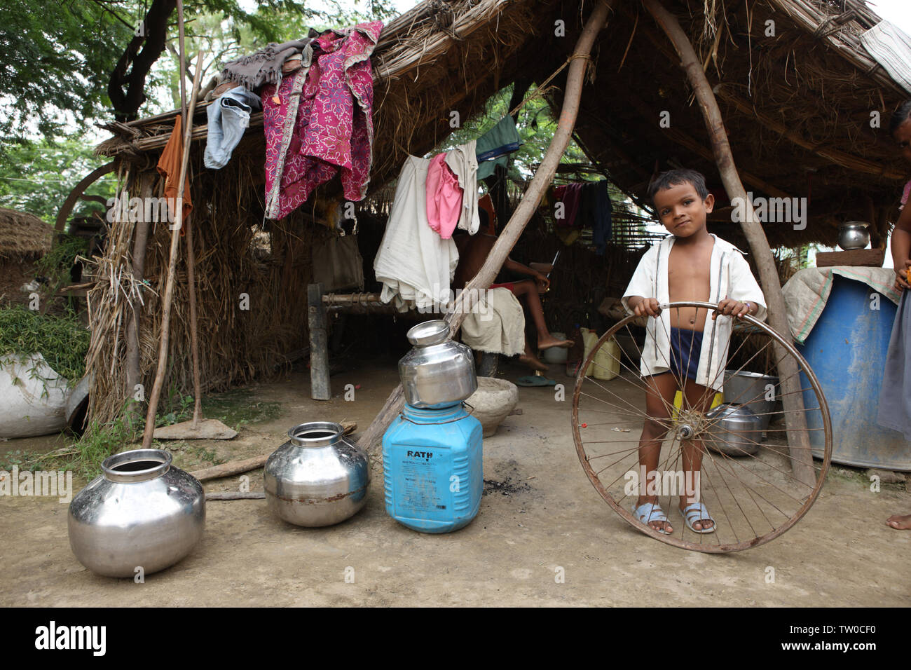 Portrait of a boy holding a bicycle rim, India Stock Photo - Alamy