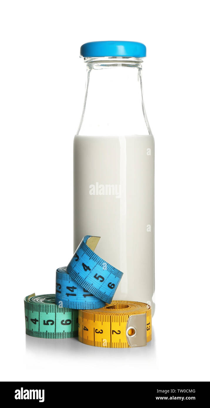 Milk diet concept. Bottle and measuring tapes isolated on white Stock ...