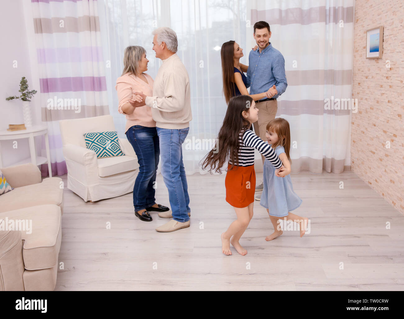 Happy big family dancing in the room Stock Photo - Alamy