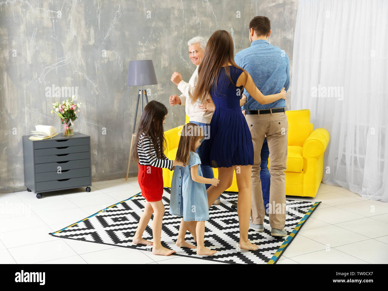 Happy big family dancing in the room Stock Photo - Alamy
