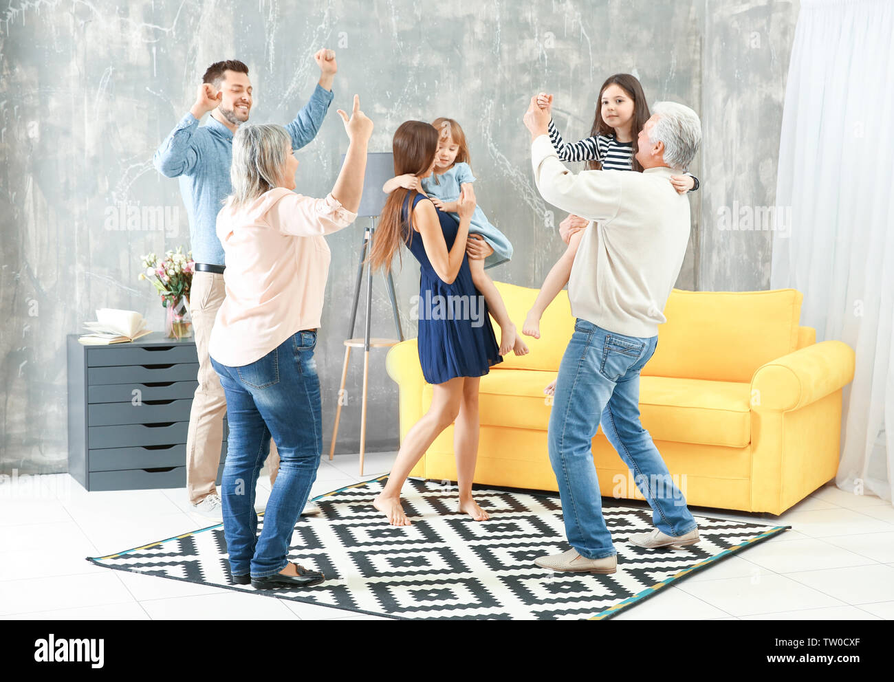 Happy big family dancing in the room Stock Photo - Alamy
