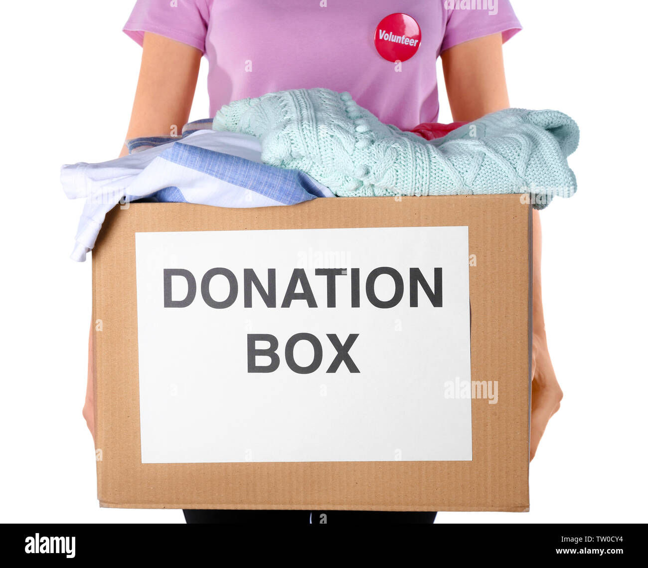Woman holding donation box with clothes on white background Stock Photo ...