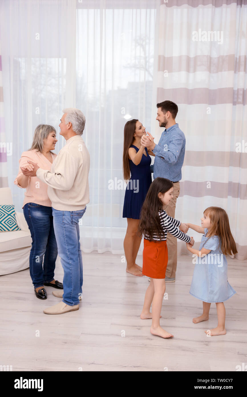 Happy big family dancing in the room Stock Photo - Alamy