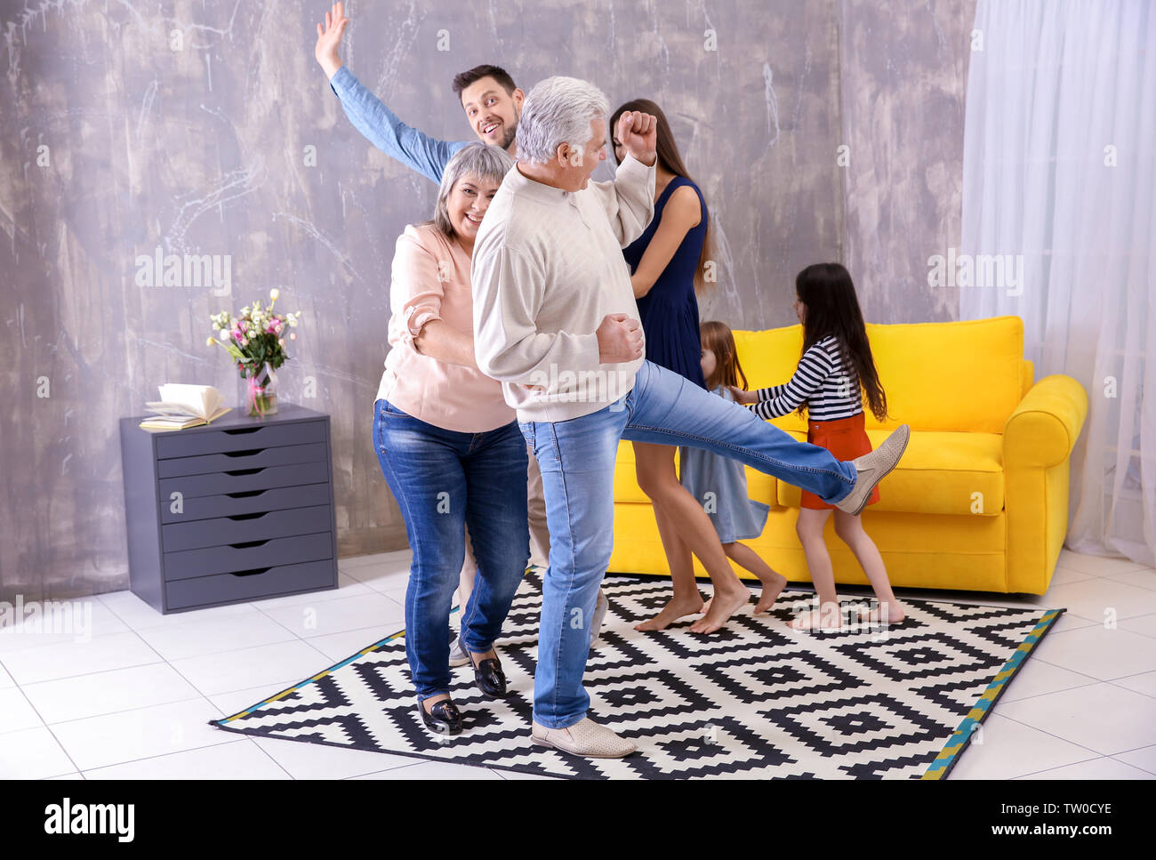 Happy big family dancing in the room Stock Photo - Alamy