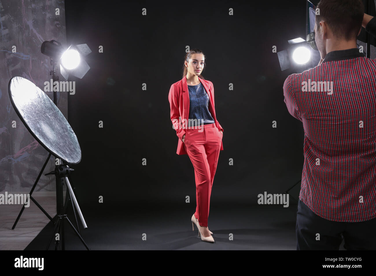 Photographer working with model in studio Stock Photo - Alamy