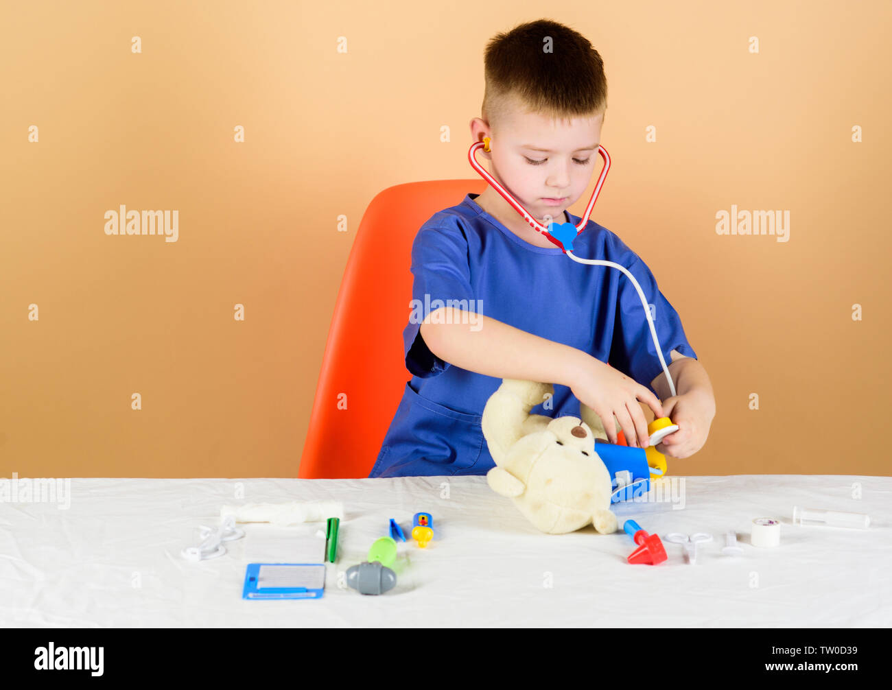 pediatrician intern. little boy in medical uniform. kid doctor with ...