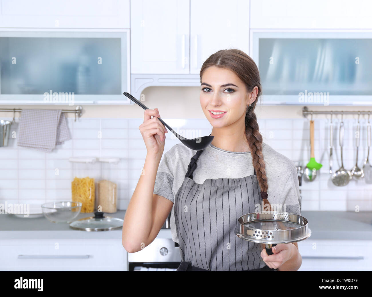 Cooking concept. Young woman tasting food Stock Photo - Alamy
