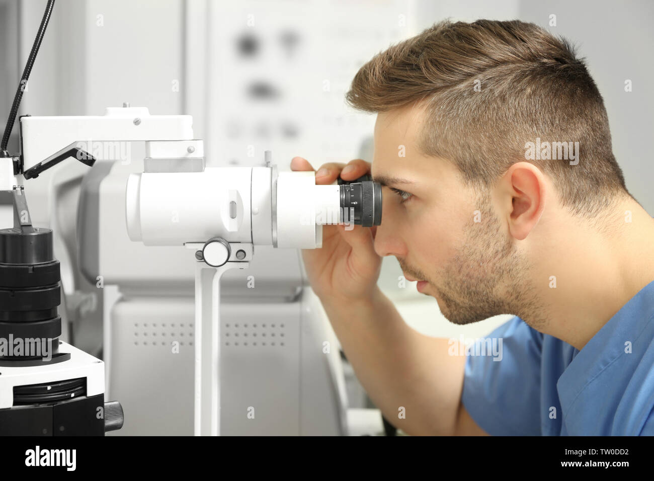 Ophthalmologist measuring intraocular pressure of patient in clinic ...