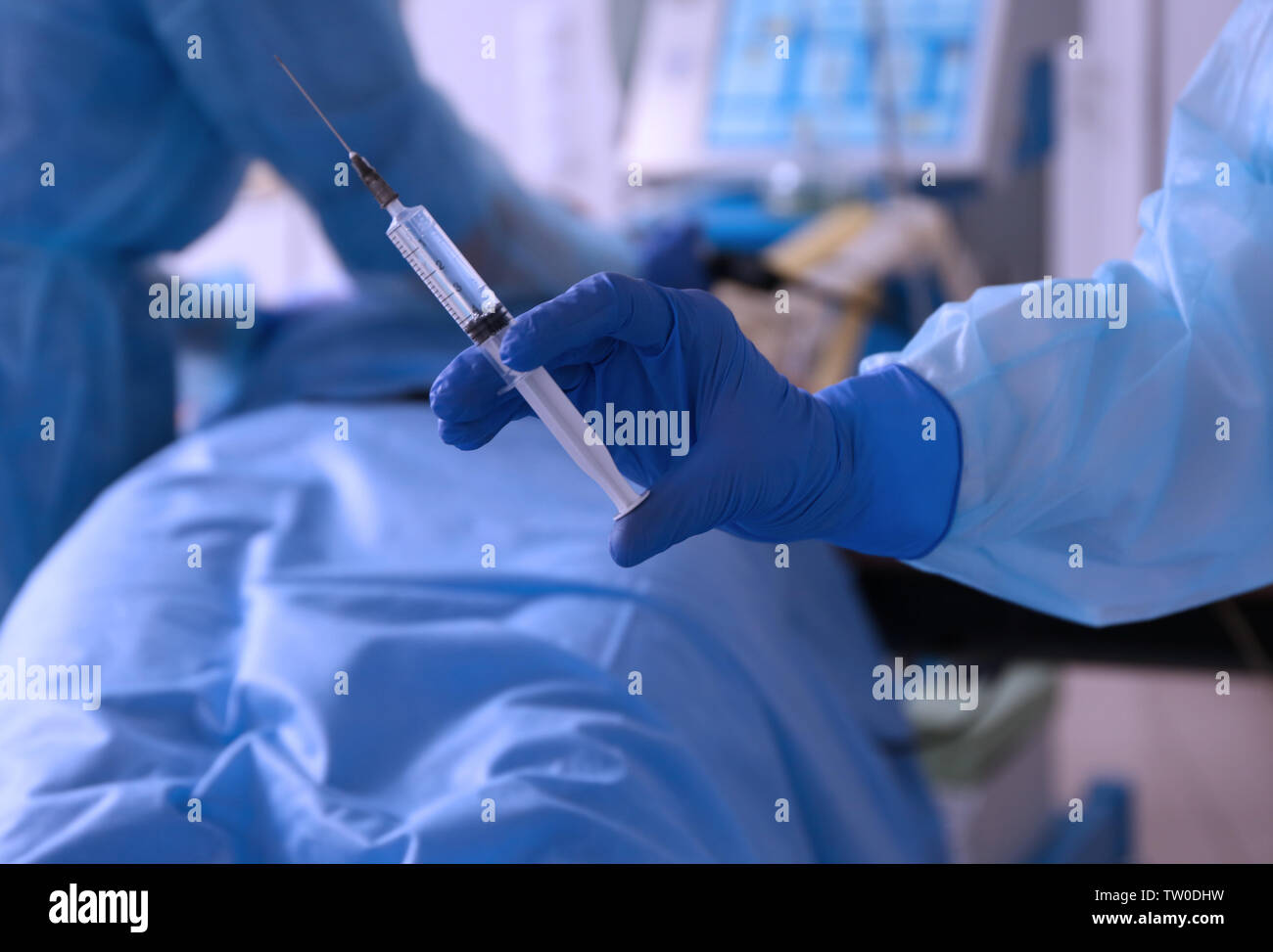 Doctor's hand with syringe in operating room Stock Photo - Alamy