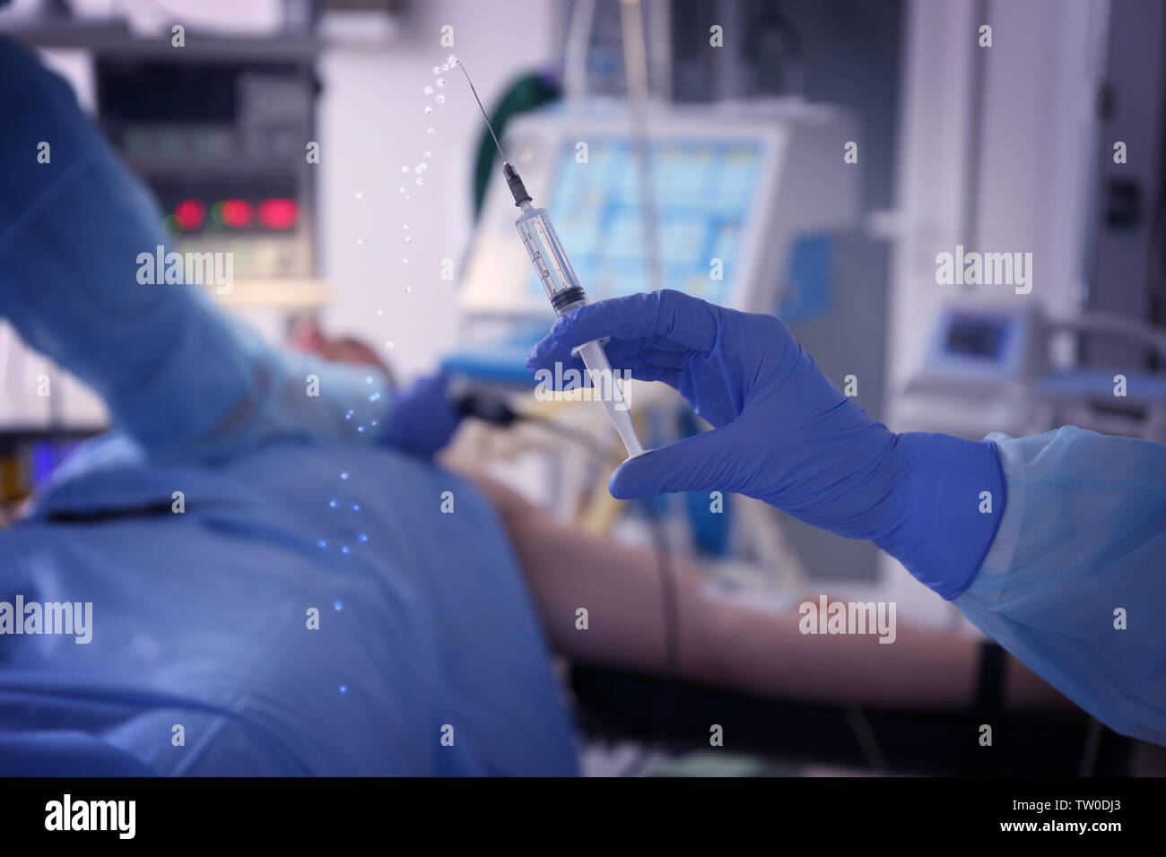 Doctor's hand with syringe in operating room Stock Photo - Alamy