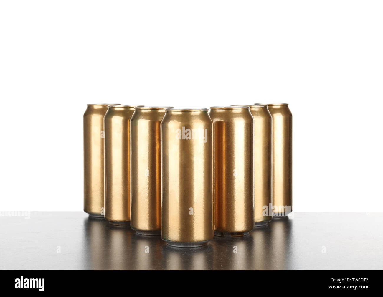 Cans of beer on table against white background Stock Photo - Alamy