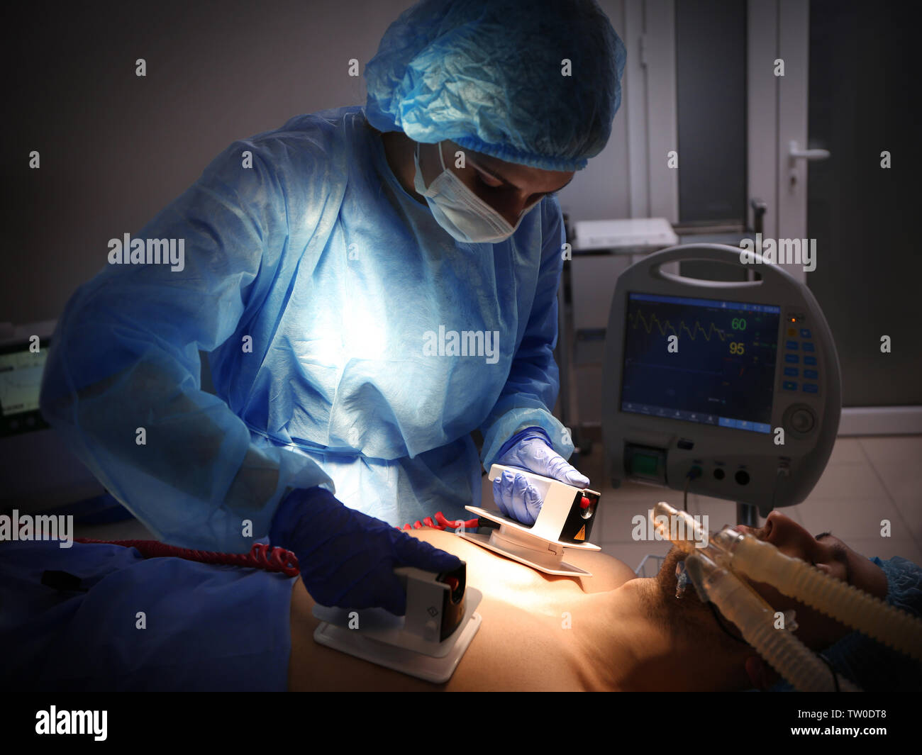 Doctor with patient heart attach hi-res stock photography and images ...