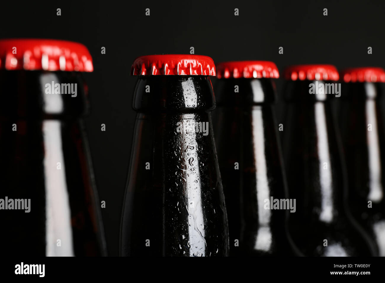 Bottles of beer on black background, closeup Stock Photo - Alamy