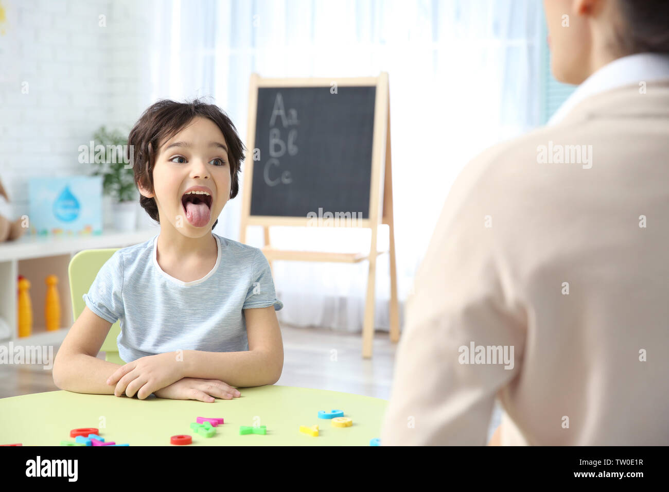 Little boy and teacher on private lesson Stock Photo - Alamy