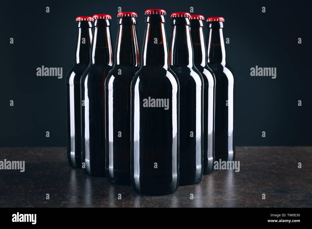 Bottles of beer on black background Stock Photo - Alamy