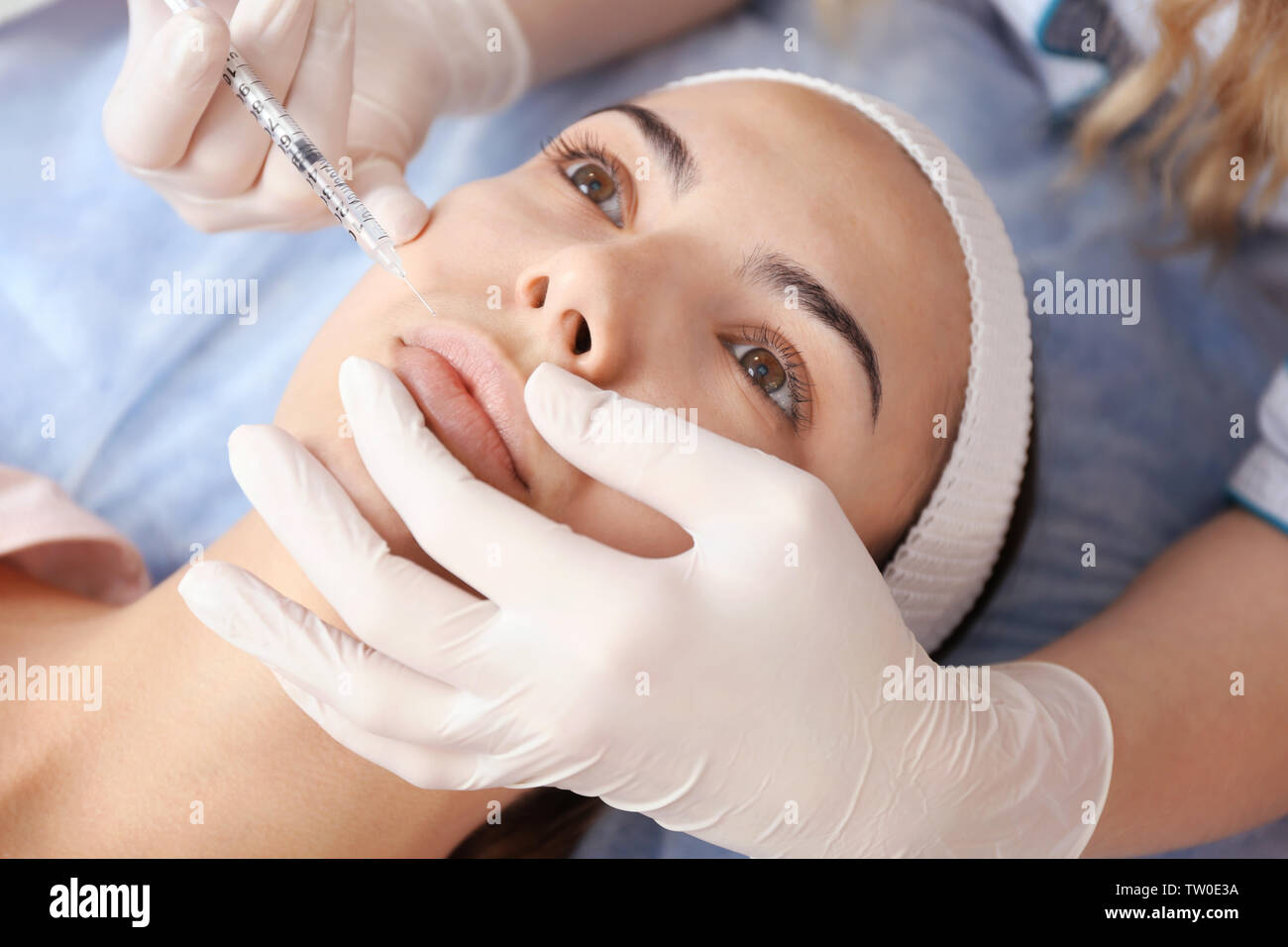 Beautician making face injections hi-res stock photography and images ...