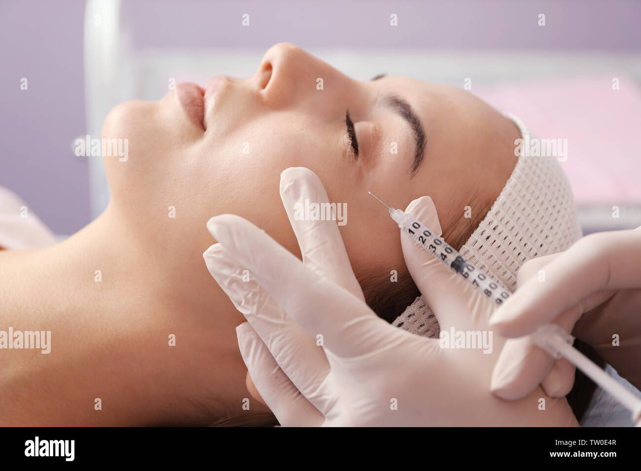 Young beautiful woman receiving facial injections in salon Stock Photo ...