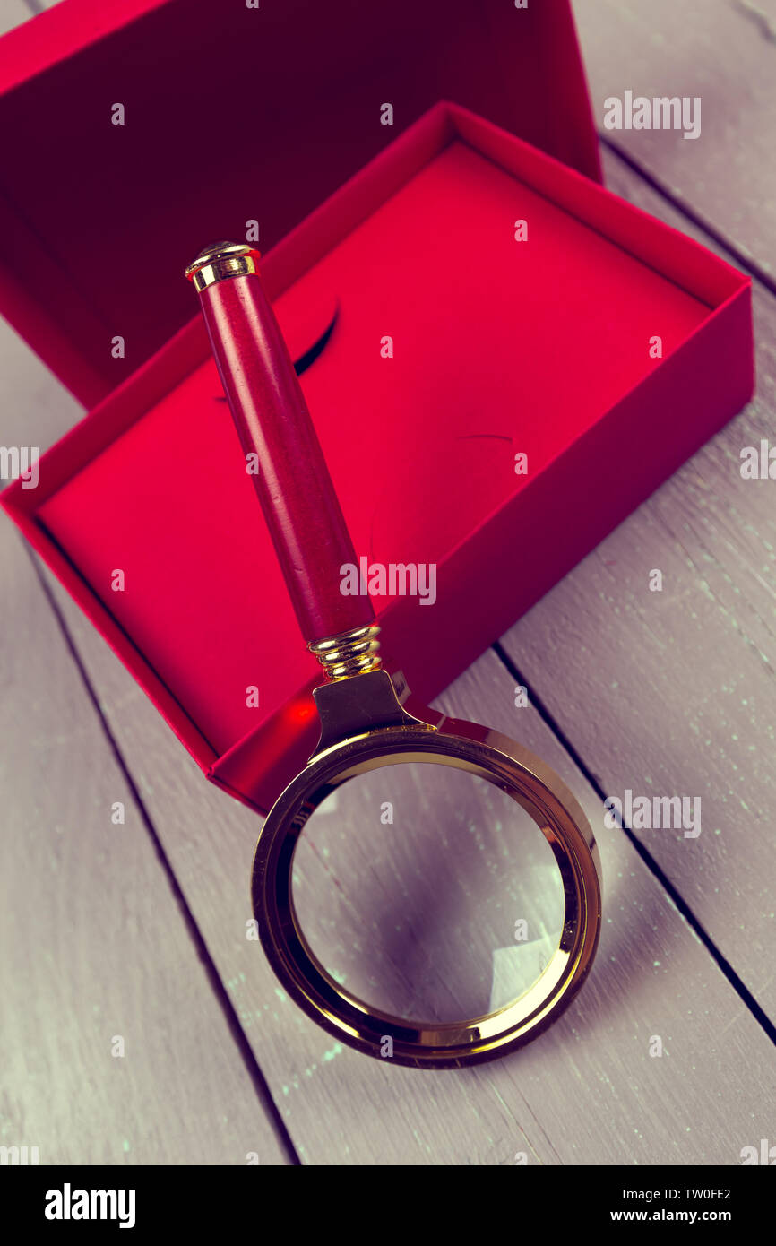 Gift box with magnifying glass Stock Photo - Alamy