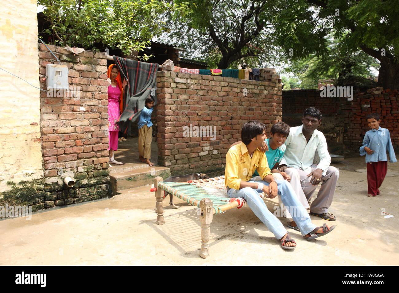 Rural people sitting on a string cot, India Stock Photo - Alamy