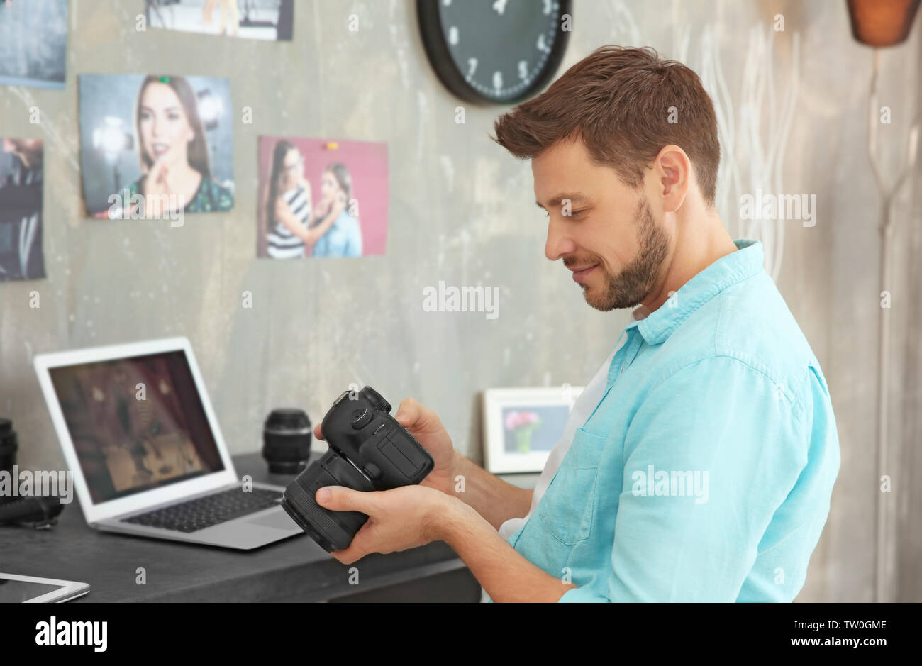 Young photographer looking at picture on camera display Stock Photo - Alamy