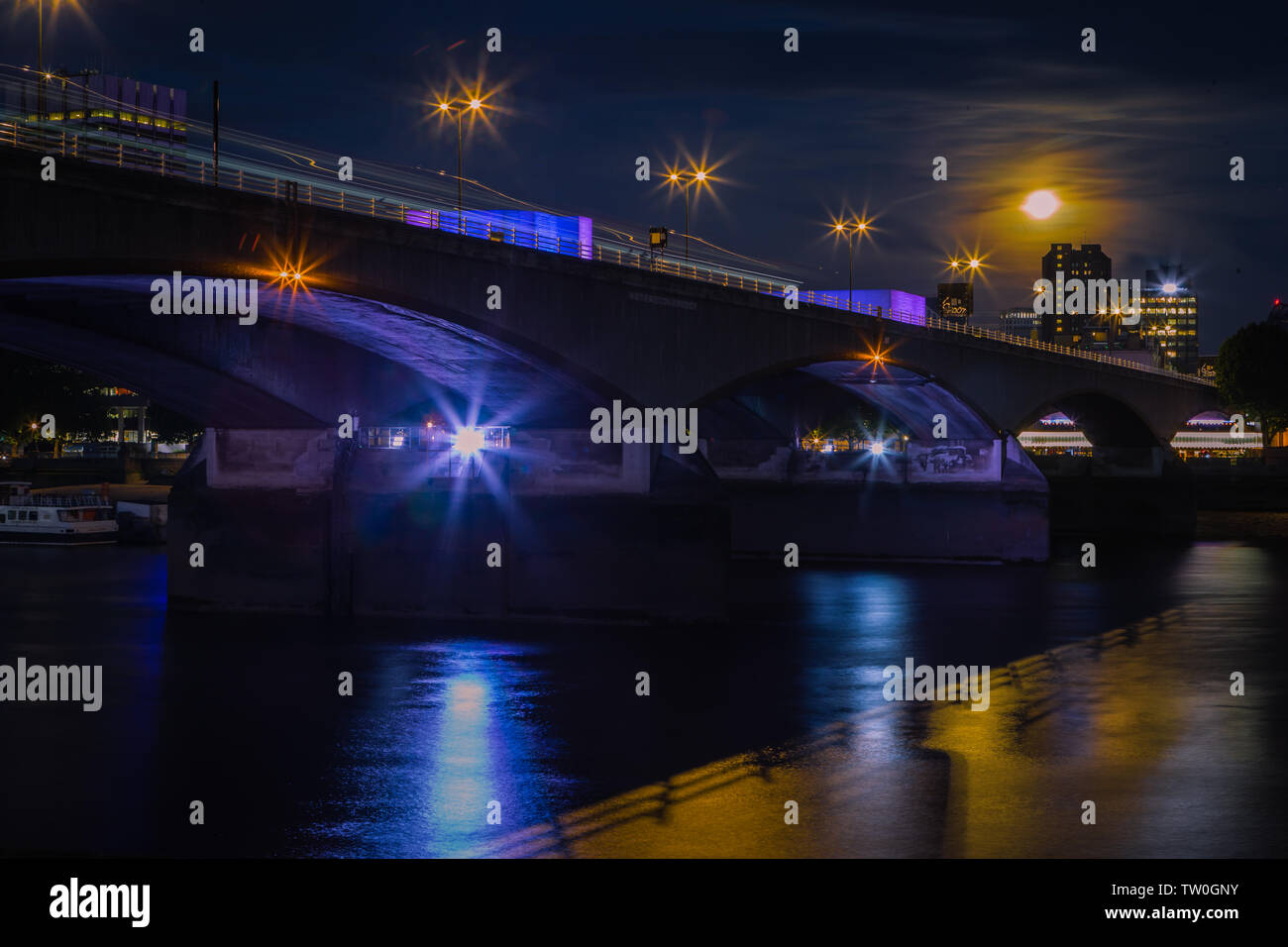 A brilliant bright orange moon rises over Waterloo Bridge in London ...