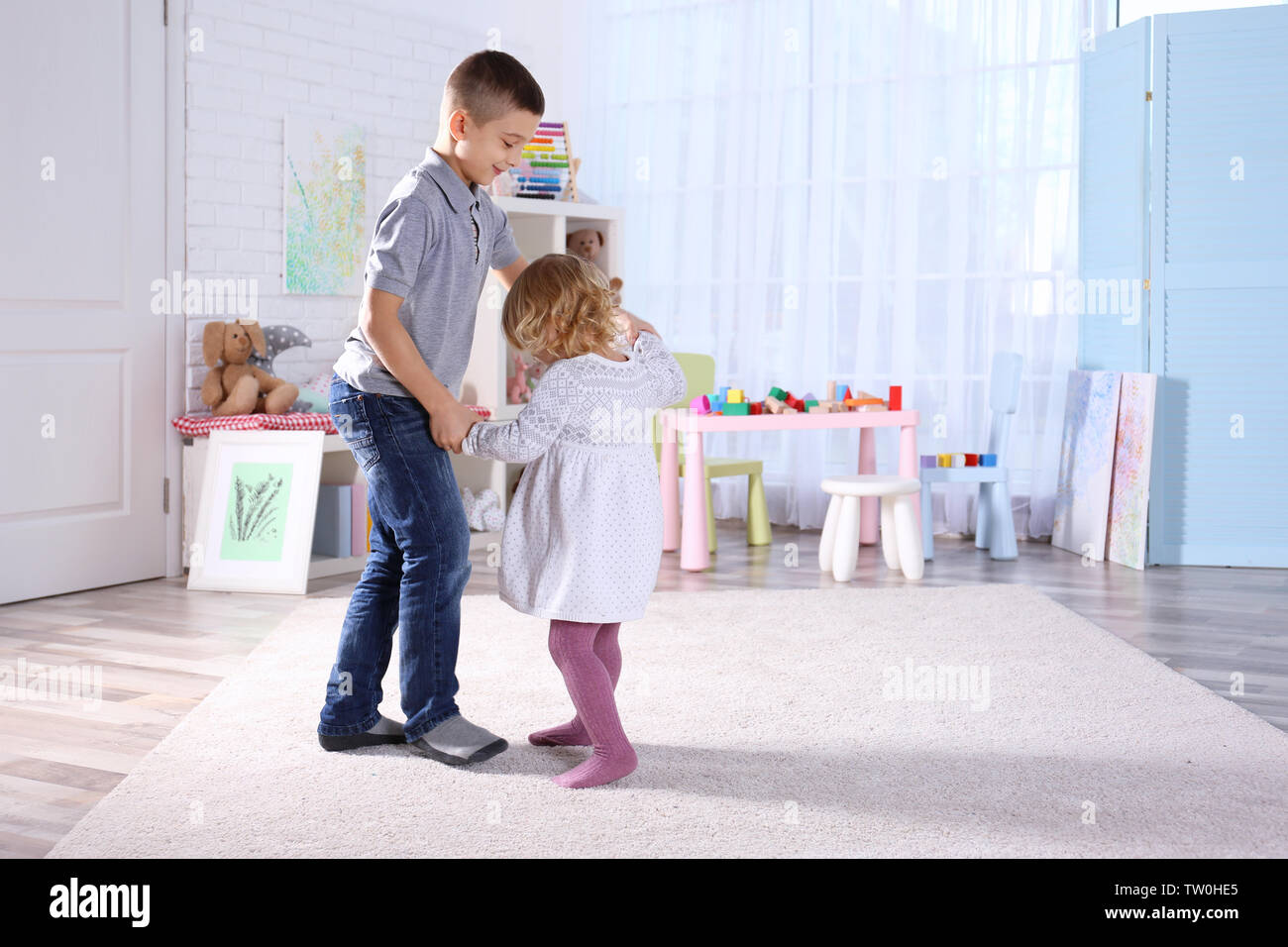 Cute little brother and sister dancing at home Stock Photo - Alamy