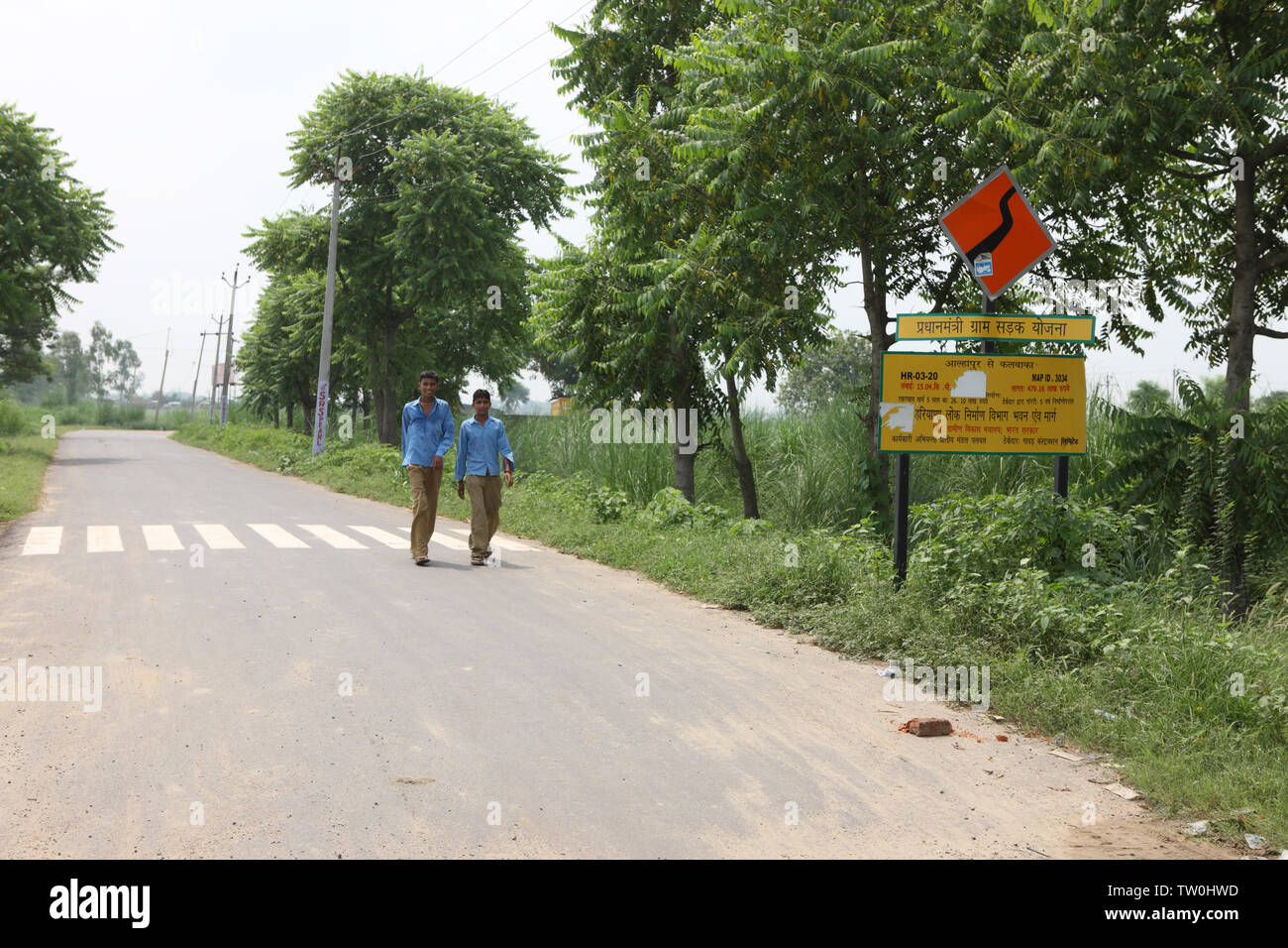 Two schoolboys walking on the road, India Stock Photo - Alamy