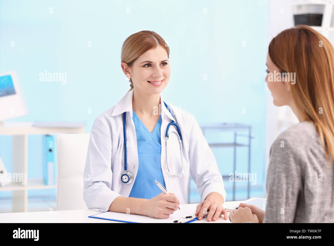 Beautiful young woman at doctor's office Stock Photo - Alamy