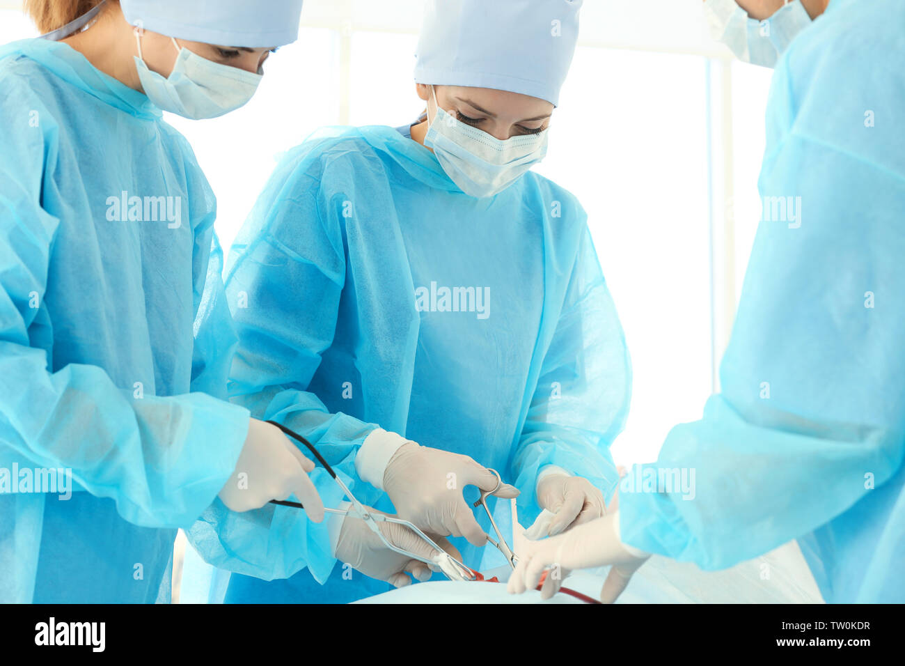 Young doctors operating patient in clinic Stock Photo - Alamy