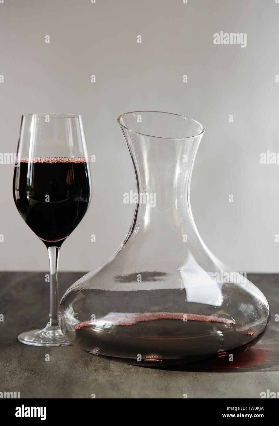 Glass carafe of red wine on gray table Stock Photo - Alamy