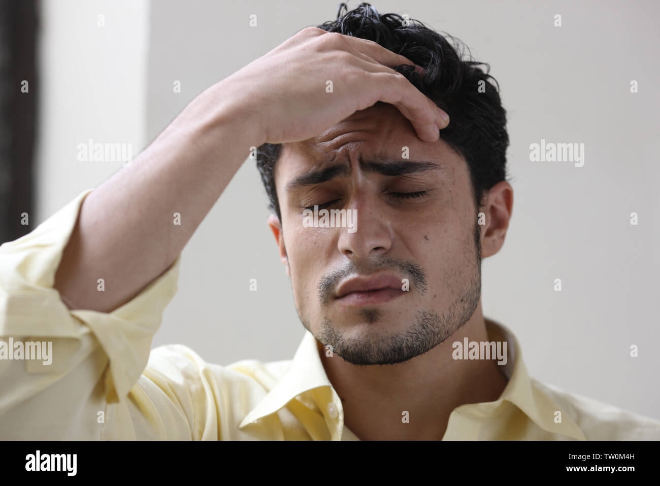 Indian young man suffering from headache Stock Photo - Alamy