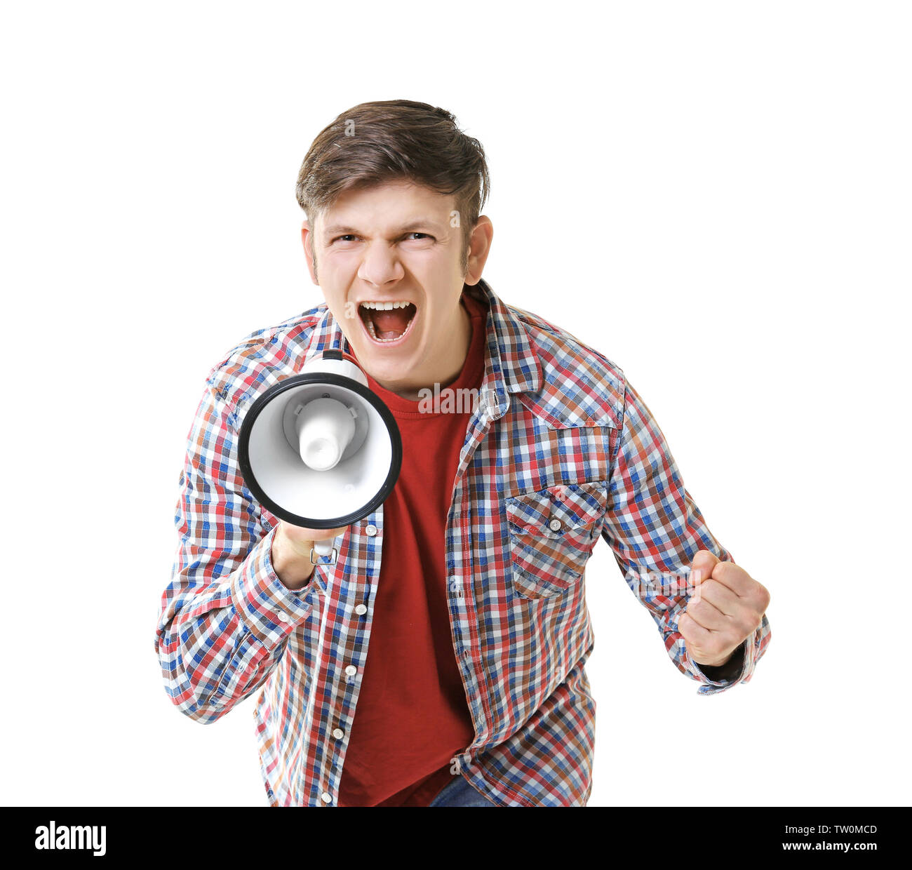 Protesting young man shouting into megaphone on light background Stock ...