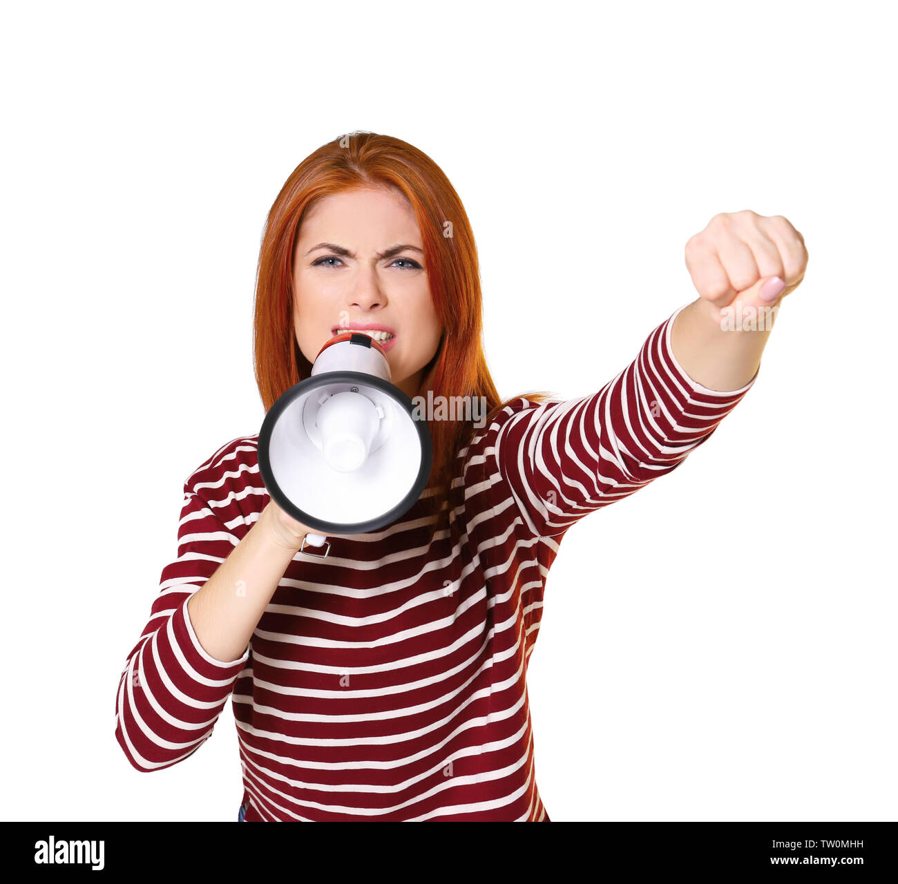 Protesting young woman shouting into megaphone on light background ...