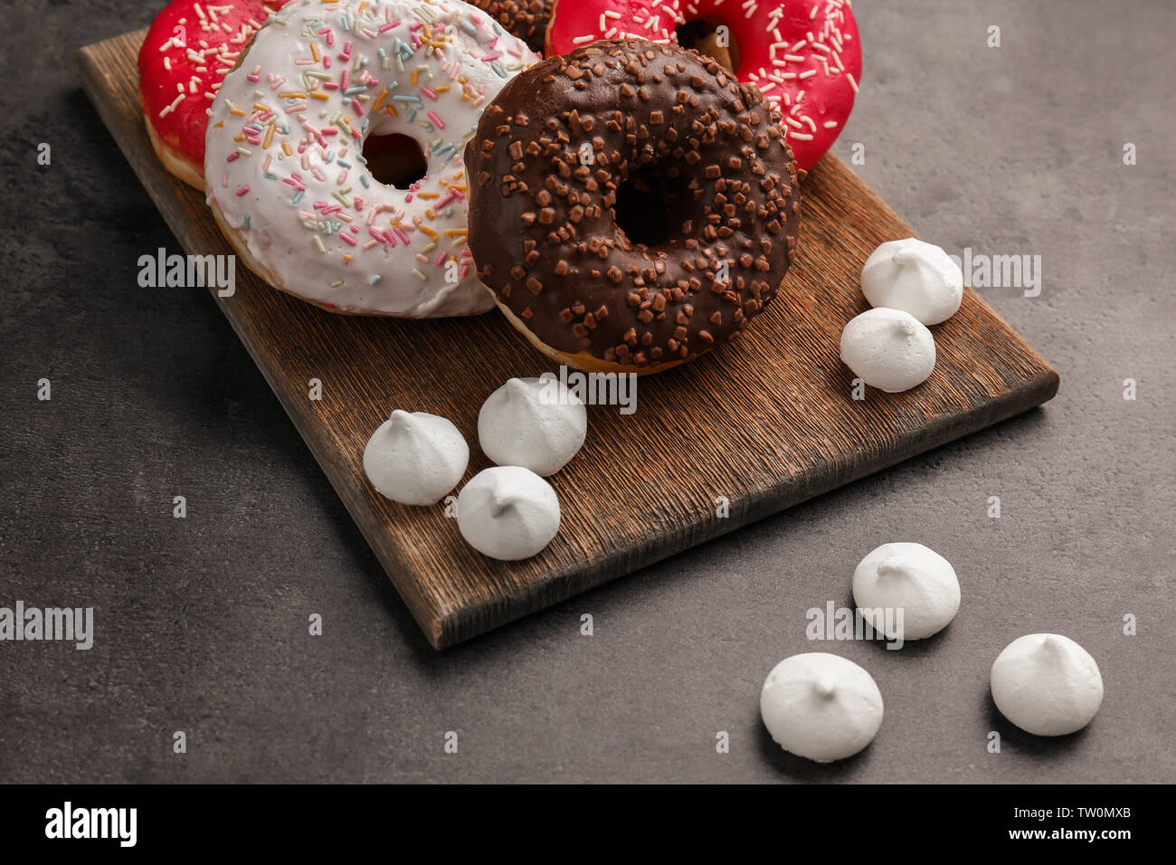 Tasty donuts on cutting board Stock Photo - Alamy