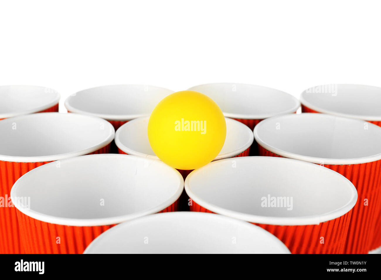 Plastic cups and tennis ball on white background. Beer pong concept ...