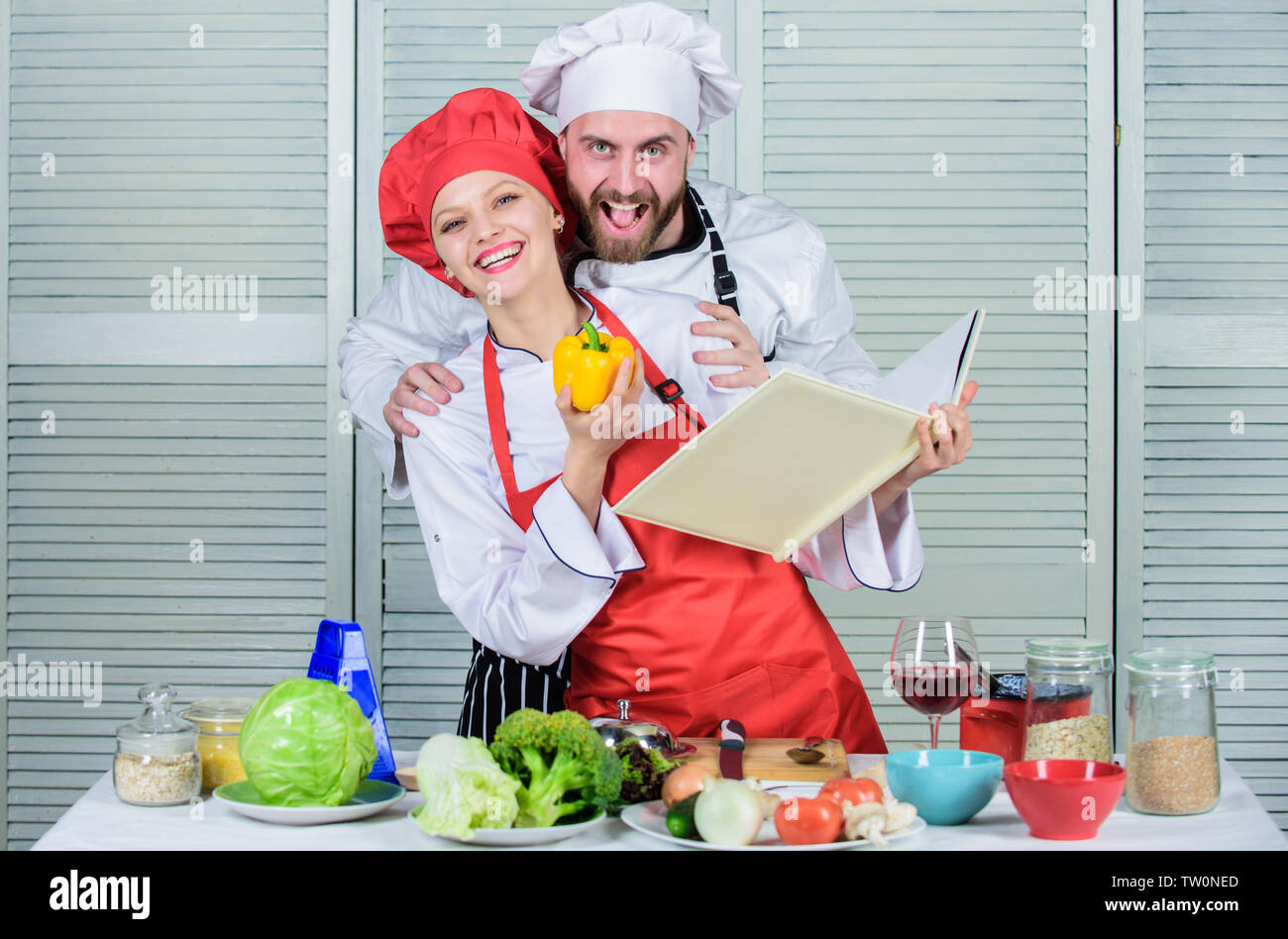 Book recipes. Helpful culinary book. Woman chef and man cooking food ...