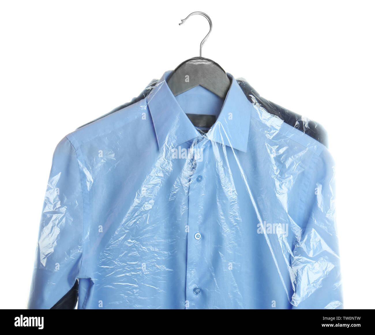 Clean clothes from dry-cleaning on white background Stock Photo - Alamy