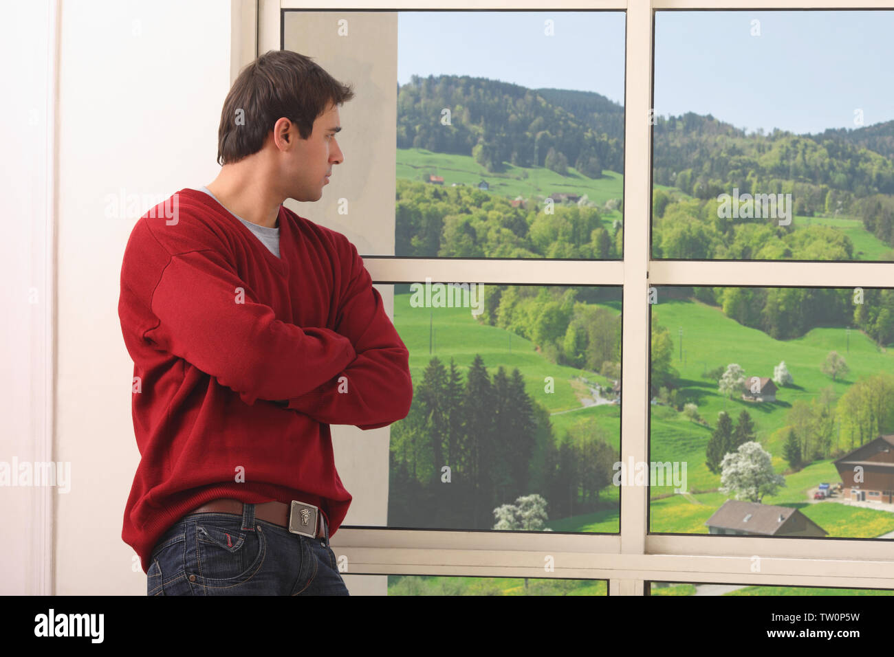 Man looking out through a window Stock Photo - Alamy