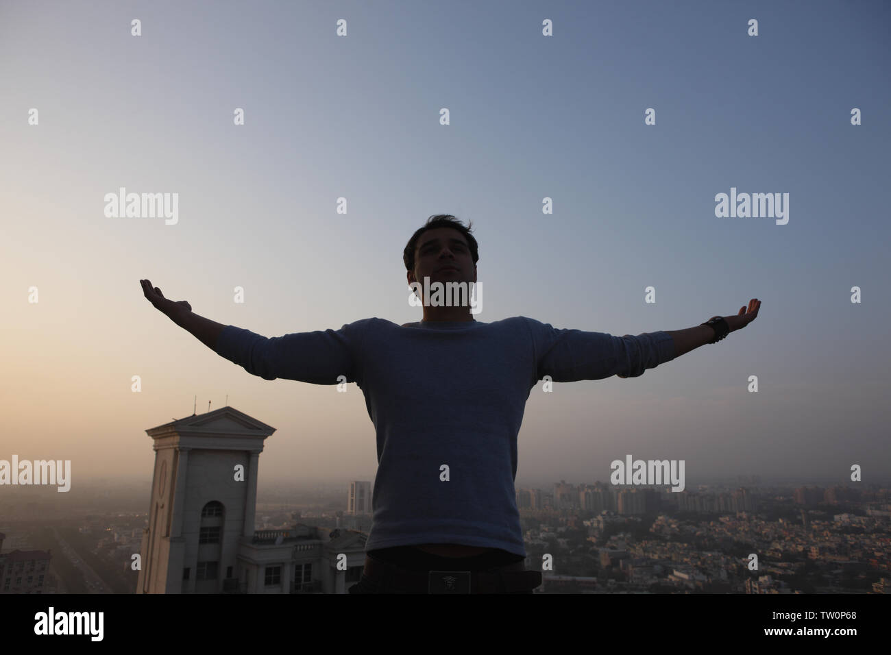 Man standing with arm outstretched, India Stock Photo - Alamy