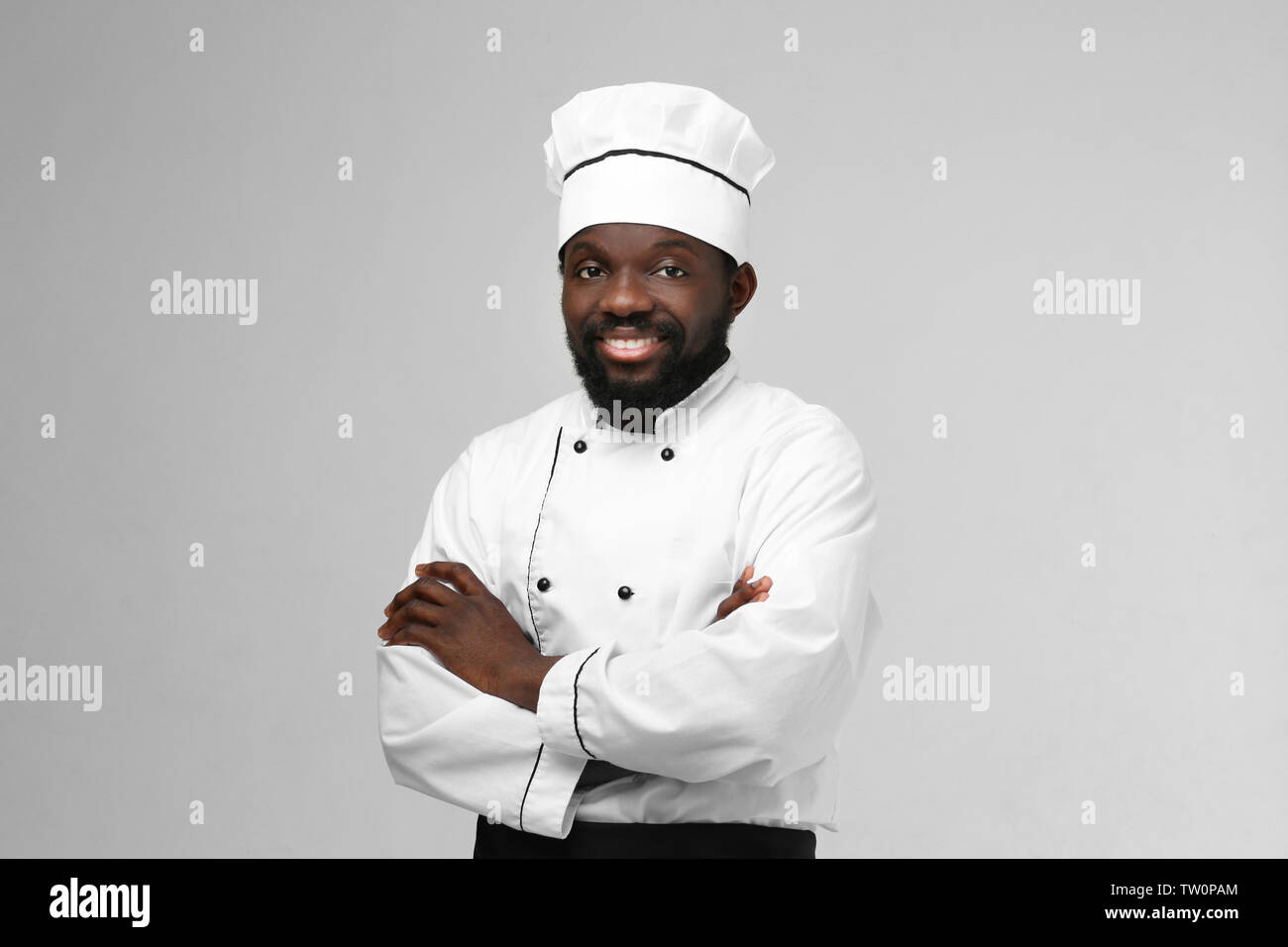 African American chef in uniform on light background Stock Photo - Alamy